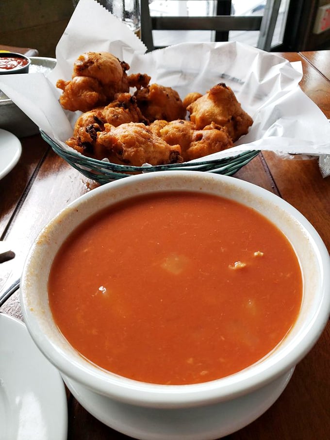 The dynamic duo of Rhode Island cuisine! Crispy clam cakes and tomato-based chowder - it's like the Batman and Robin of comfort food, minus the capes.