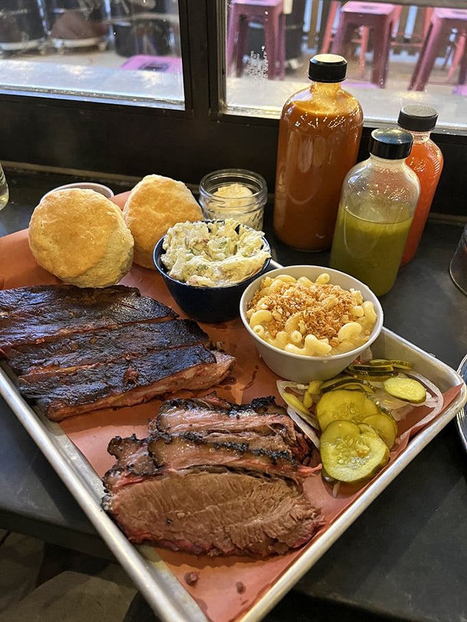 Nature's perfect pairing: mac and cheese with crispy breadcrumb topping alongside ribs and brisket that render silverware suggestions rather than requirements.