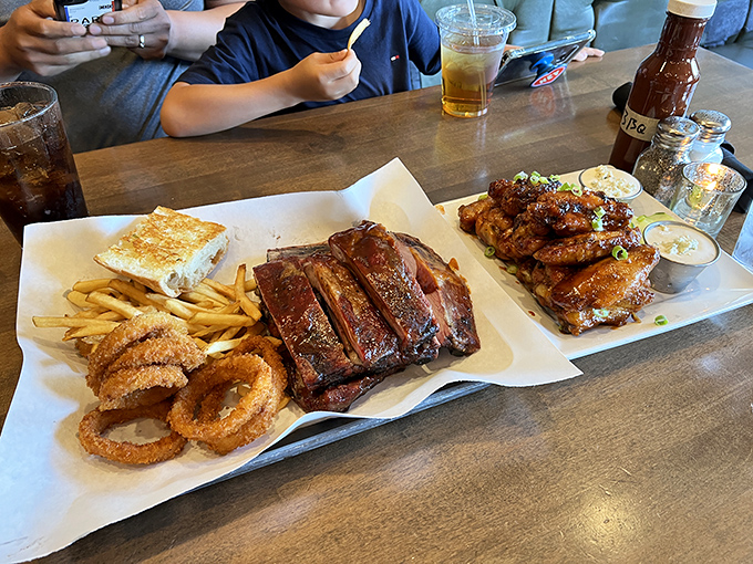 When ribs meet fries and onion rings, it's the kind of feast that requires strategic eating and zero shame about the sauce on your shirt.
