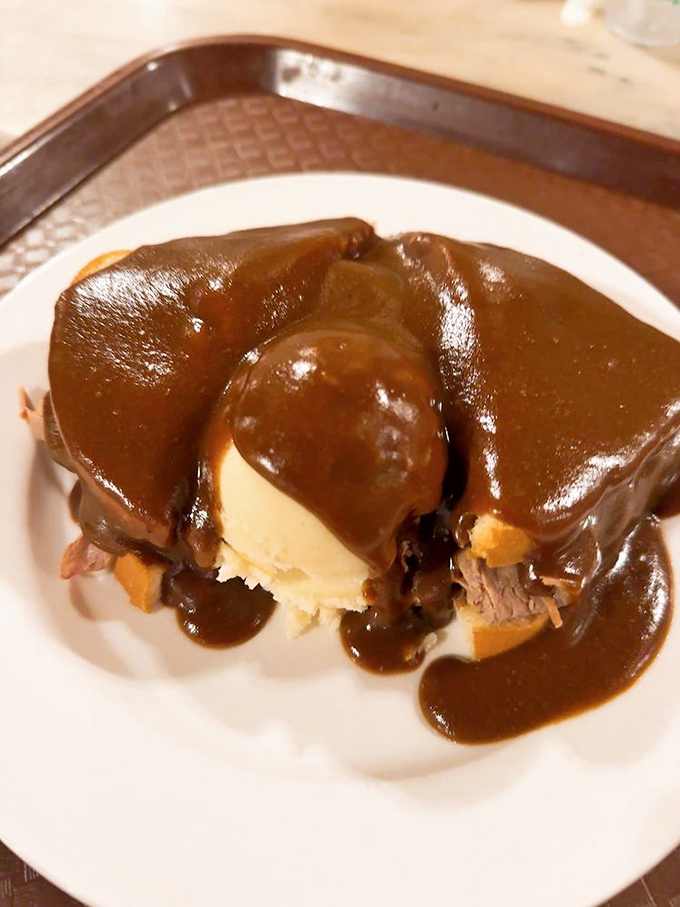 Behold, the hot beef sandwich &ndash; Wall Drug's answer to "What if gravy could hug?" It's comfort food so comforting, it practically tucks you in for a nap afterward.