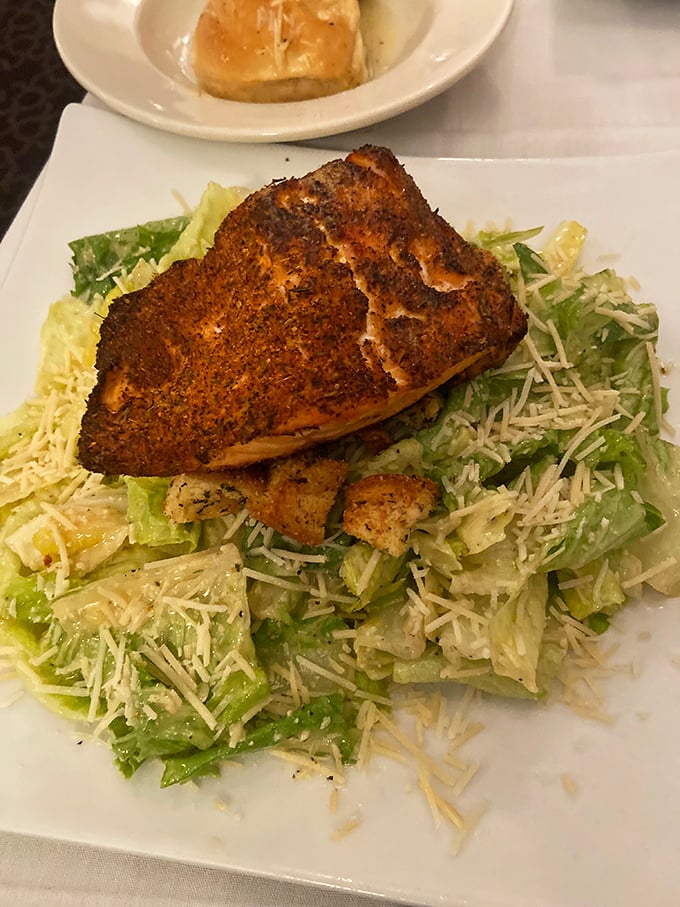 This blackened salmon perched atop a Caesar salad isn't just lunch&mdash;it's a midday vacation for your taste buds.