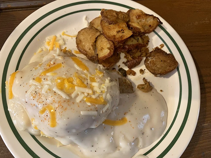 This plate is what breakfast dreams are made of &ndash; a golden biscuit swimming in creamy sausage gravy, with a side of crispy potatoes.