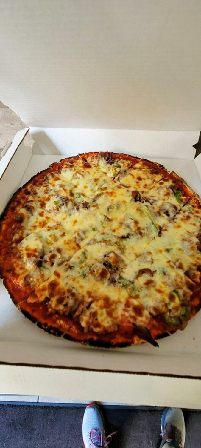 Meat lover's paradise! This pizza's piled higher than a Chicago skyscraper, with beef and sausage stealing the show. Garlic breath? Worth it.