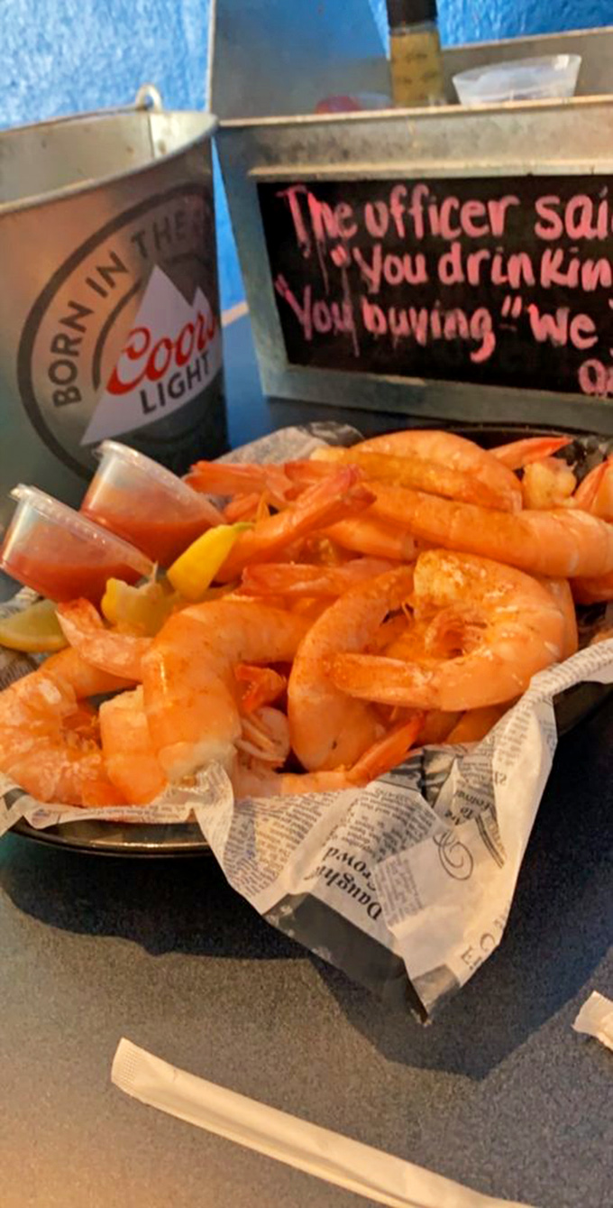 Shrimp cocktail gets a makeover! These plump crustaceans are lounging in their newspaper hammock, waiting to take a dip in cocktail sauce.