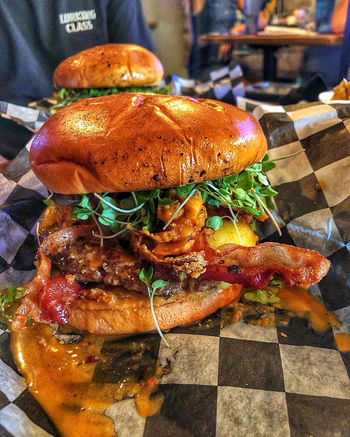 Holy flavor explosion, Batman! This burger's got more layers than a Christopher Nolan film, and it's just as mind-bending.