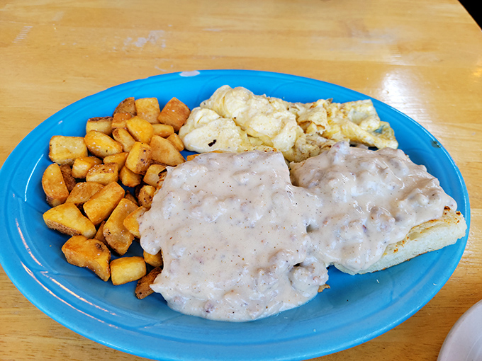 Golden biscuits, creamy gravy, and eggs that could make a rooster jealous. This plate is the breakfast equivalent of winning the lottery.