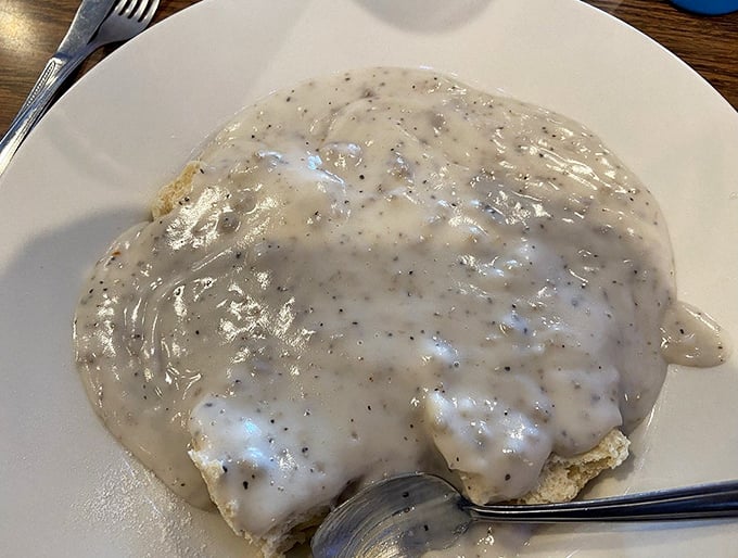 Gravy so good, you'll want to swim in it. These biscuits aren't just covered; they're embraced by a creamy, peppery hug that'll warm your soul.