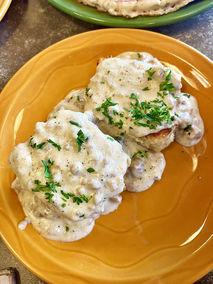 These biscuits aren't just golden, they're 24-karat breakfast perfection. Smothered in gravy and sprinkled with herbs, they're the crown jewels of comfort food.