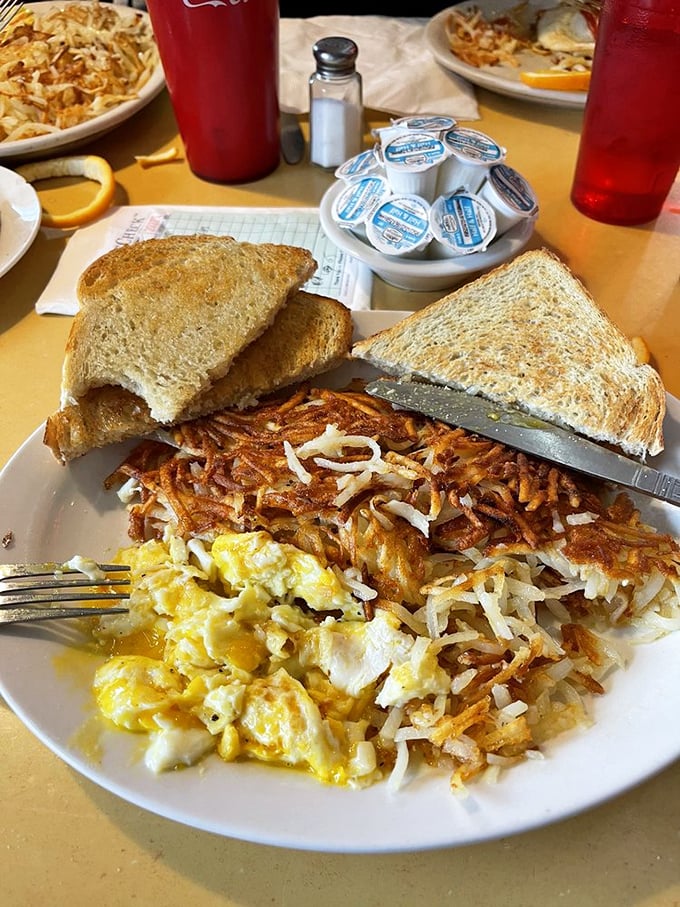 Breakfast of champions, or anyone who appreciates a plate that's more "yes" than "yolk." Eggs, hash browns, and toast &ndash; the holy trinity of morning indulgence.