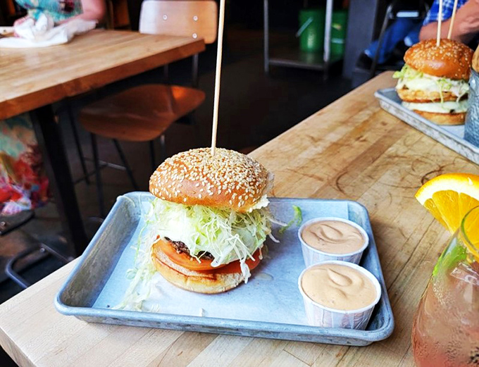 Behold, the burger of your dreams! This masterpiece is stacked higher than your grandkid's Lego tower, and twice as likely to bring a smile to your face.