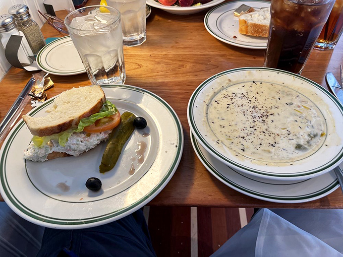 The dynamic duo of comfort food: clam chowder and a seafood sandwich. It's like a warm hug for your taste buds.
