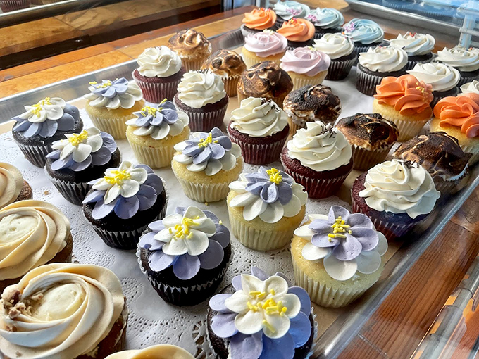 These artisan cupcakes aren't just desserts, they're edible works of art topped with delicate flower designs.