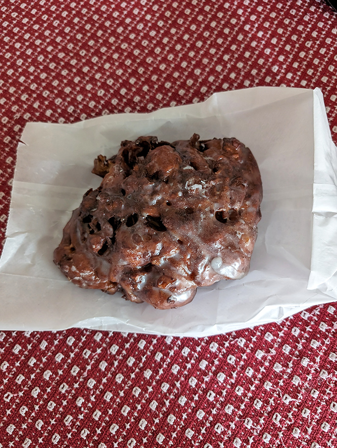 Behold the chocolate fritter in its natural habitat&mdash;wax paper. The irregular shape tells you it's handmade, and the glaze promises it's worth every calorie.
