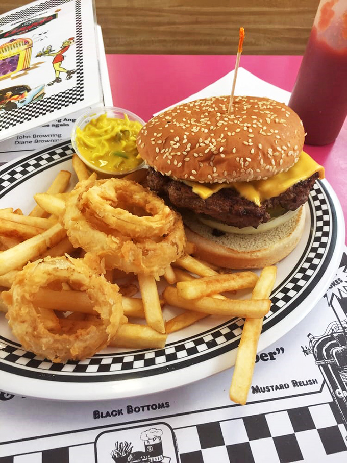 Meet the Goliath &ndash; a burger so epic, it needs its own ZIP code! Nestled alongside golden onion rings and crispy fries, it's a meal fit for a king... or a very hungry commoner.