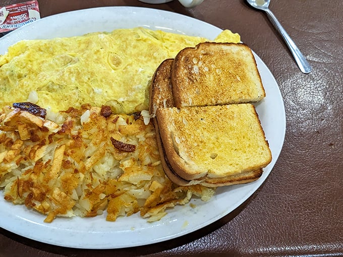 Witness the omelet in its natural habitat: perfectly folded, generously stuffed, and ready to make your taste buds do a happy dance.