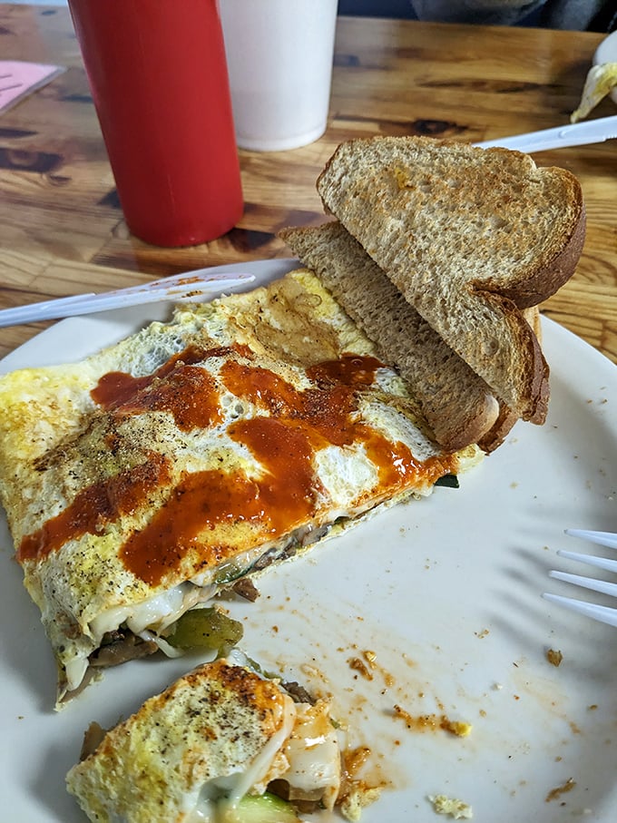 This omelet's got more layers than a Shakespeare play, and it's just as dramatic. That sauce? Pure breakfast poetry.