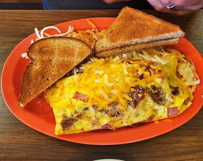 This omelette is so packed, it could apply for its own zip code. Cheese for days and a side of crispy hash browns? Breakfast nirvana achieved!