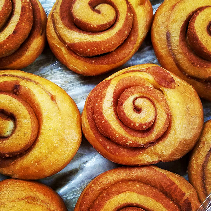 Behold, the cinnamon roll in its natural habitat. These golden spirals are what dreams are made of &ndash; if your dreams involve swimming in rivers of cinnamon and sugar.