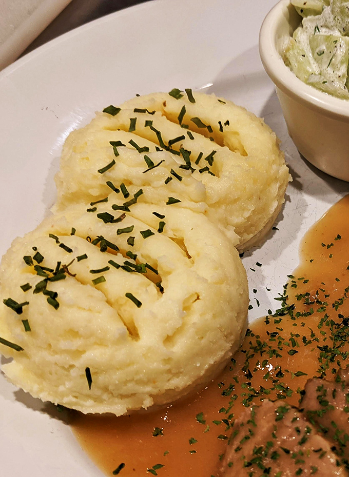 Mashed potatoes sculpted with the precision of Michelangelo. These buttery mounds, sprinkled with chives, aren't just a side dish&mdash;they're the main event.