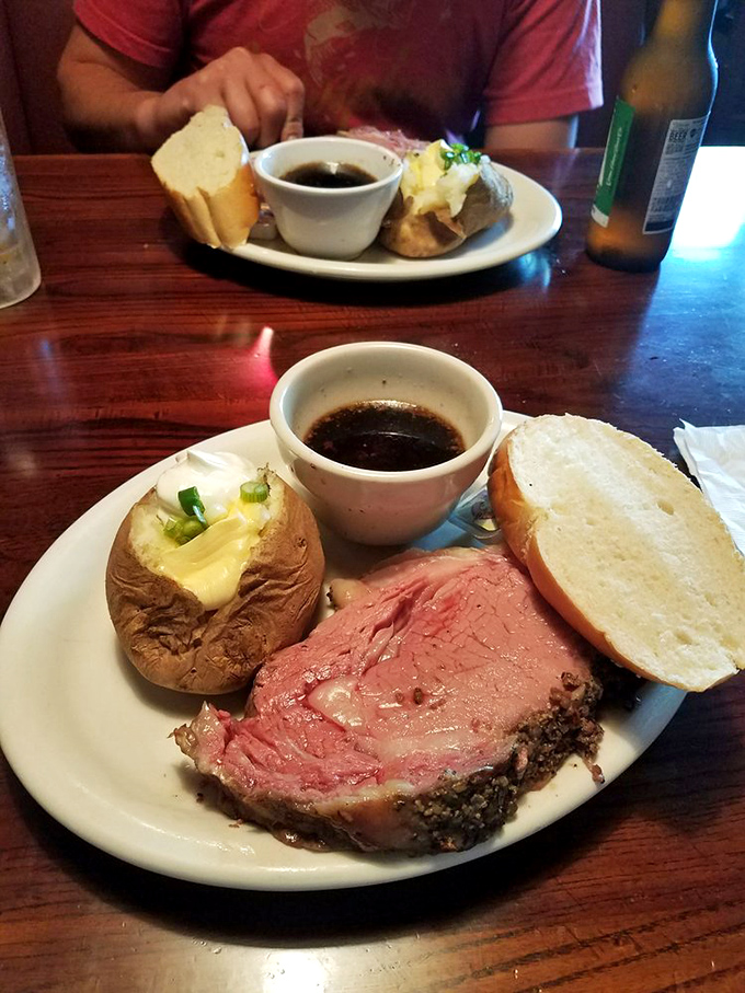A plate that screams "Midwest magic"! Juicy prime rib, fluffy baked potato, and bread that's begging to sop up every last drop of au jus.