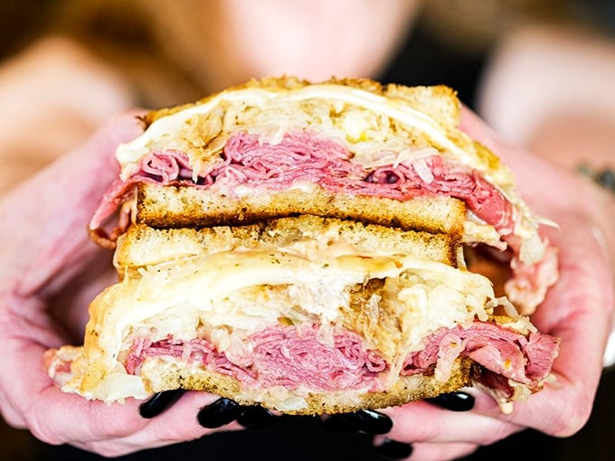 Behold, the Leaning Tower of Reuben! This sandwich has more layers than a Shakespeare play, and it's just as dramatic.
