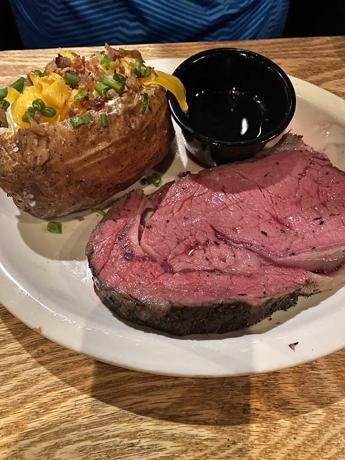 Poetry on a plate: perfectly pink prime rib alongside a twice-baked potato that's dressed more impressively than most people at formal events.