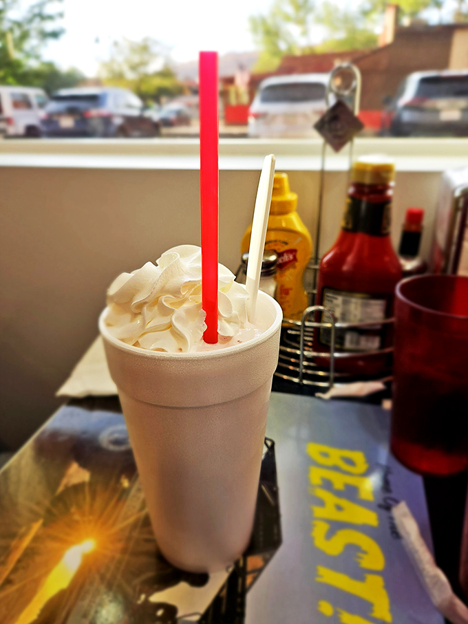 Is it a milkshake or modern art? This creamy masterpiece comes with its own red-and-white striped straw, ready for your sipping pleasure.