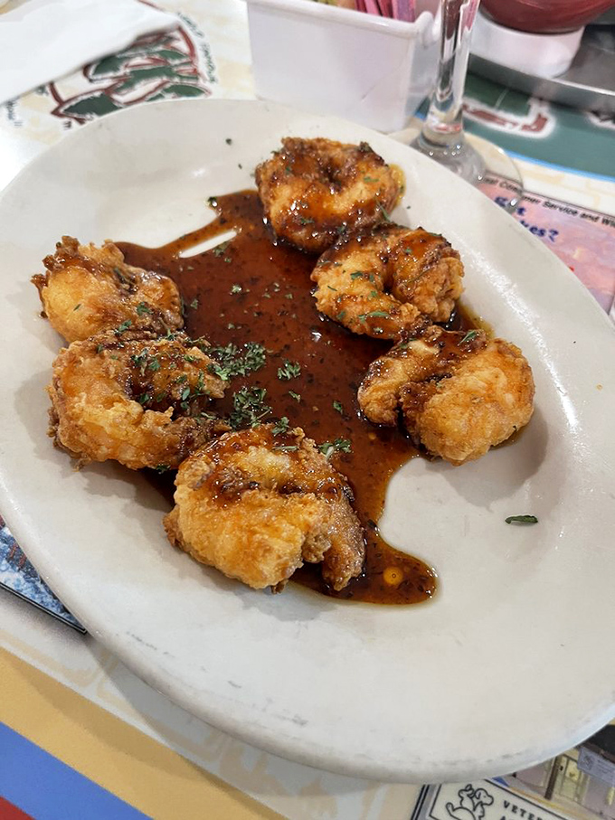 Shrimp that'll make you weak in the knees! These golden-fried crustaceans are like crispy, savory jewels from the sea. Resistance is futile!