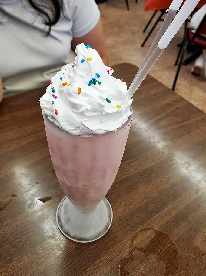 Pretty in pink and topped with joy! This strawberry shake isn't just a drink; it's a carnival in a glass, complete with its own colorful confetti.