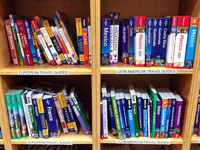 Armchair traveler's paradise! Whether you're planning a trip or just dreaming, these shelves are your passport to adventure.