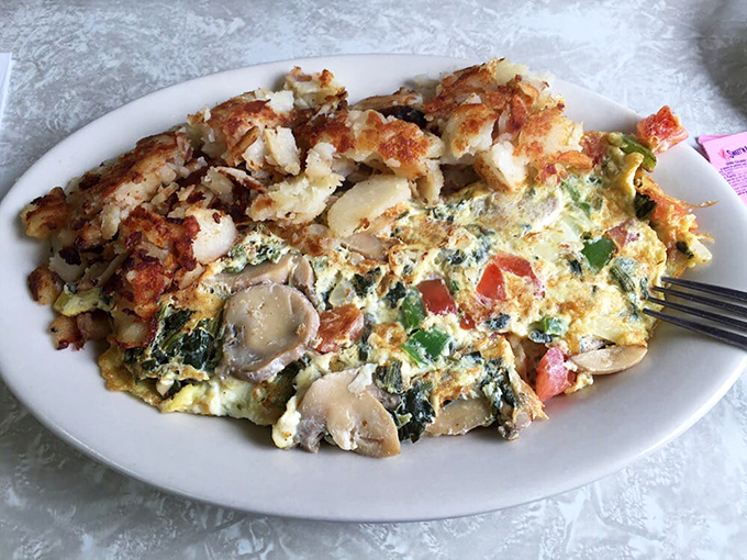 Who says you can't have your veggies and eat them too? This omelet is like a garden party wrapped in a fluffy egg blanket.