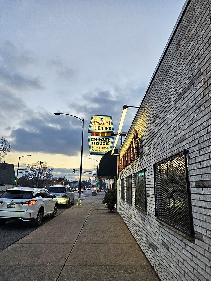 Mancini's neon sign could guide you through a film noir. Inside, the steaks are the real stars of this classic production.