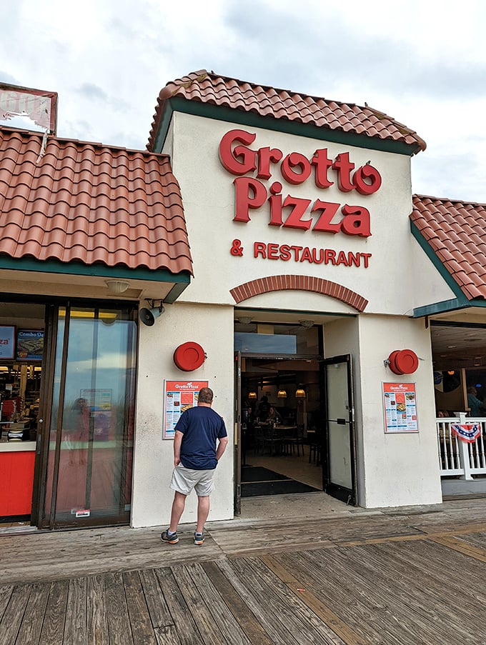 That distinctive terra cotta roof has sheltered generations of beachgoers seeking refuge from the sun and mediocre pizza alternatives.