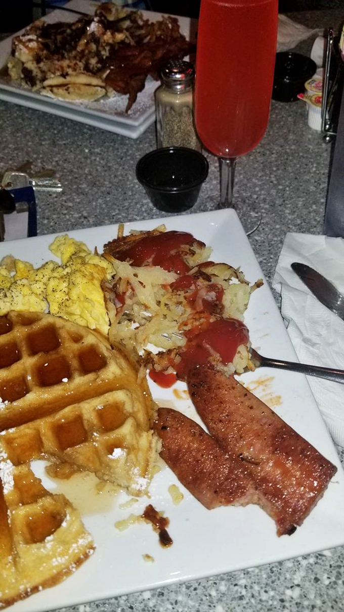 The holy trinity of breakfast: Golden waffles, smoky sausage, and eggs sunny-side up. Good morning, indeed!