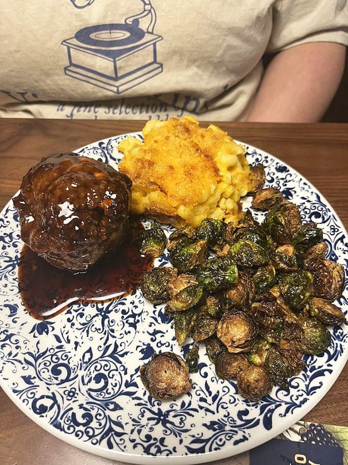 A meatloaf that would make your grandmother jealous sits proudly beside the star attraction&mdash;mac and cheese with a crust that deserves its own fan club.