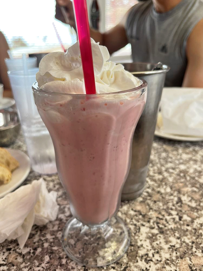 Holy moly, that's a milkshake! Topped with a cherry so perfect, it looks like it's auditioning for a Norman Rockwell painting.