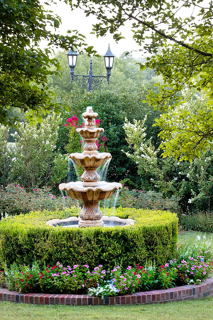 "A Fountain of Tranquility" This picturesque garden scene is so serene, you half expect a Disney princess to burst into song at any moment.