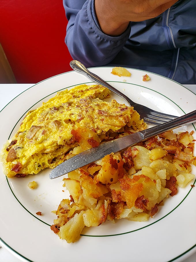 This isn't just an omelet&mdash;it's a golden envelope of happiness, delivering joy alongside those perfectly crisped home fries.