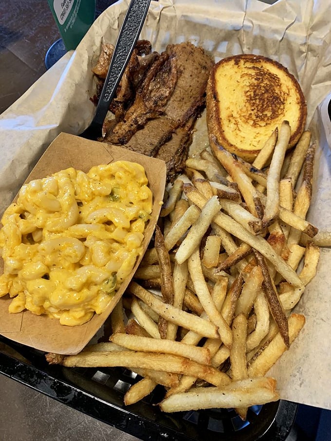 Brisket sliced like butter, tender enough to cut with a harsh word, paired with creamy mac and cheese that's basically comfort in a boat.