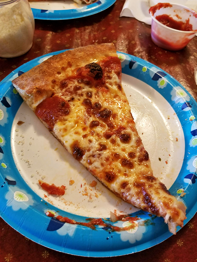 One bite of this golden-crusted beauty, and you'll understand why Rosa's pizza has more fans than a North Dakota wind farm.