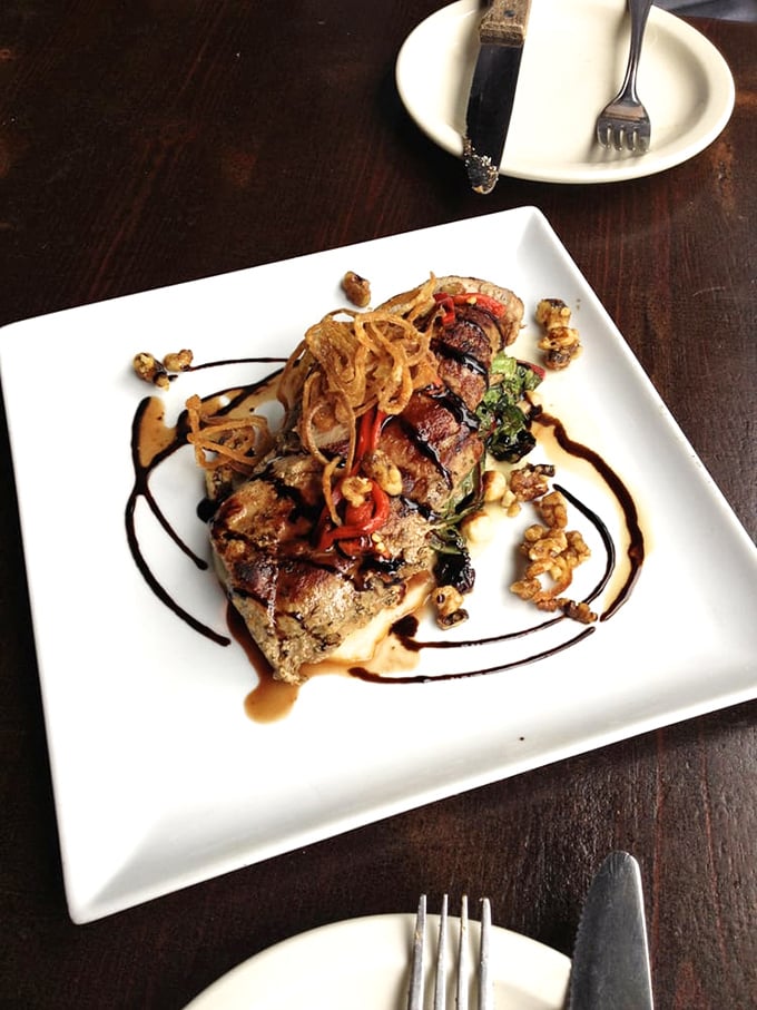 Behold the pork tenderloin in its natural habitat&mdash;dressed in a reduction so rich it could buy a vacation home in Buckhead.