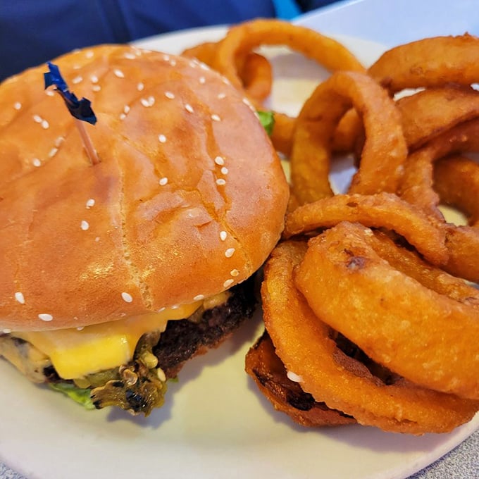 Holy cow, what a burger! Paired with those golden onion rings, it's a dynamic duo that would make Batman and Robin jealous.