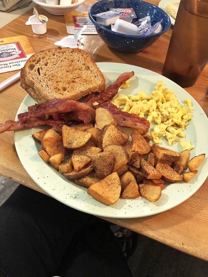 The breakfast of champions: Crispy bacon, fluffy eggs, and toast that could make a carb-counter weep. Who needs alarm clocks when this is waiting?