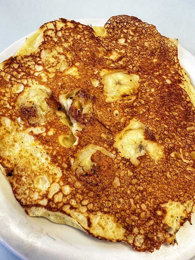 This banana pancake has more perfect bubbles than a Lawrence Welk show. The caramelization is what pancake dreams are made of.