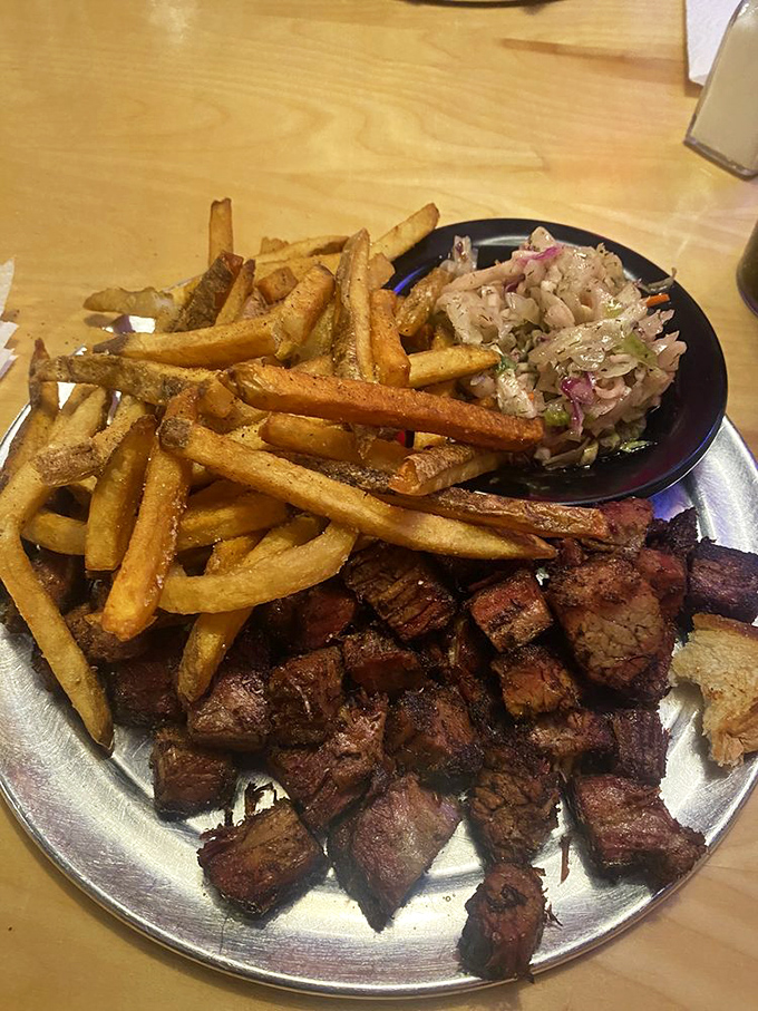 Burnt ends: where patience meets perfection. These caramelized brisket bites with golden fries and tangy slaw are Missouri's answer to culinary happiness.