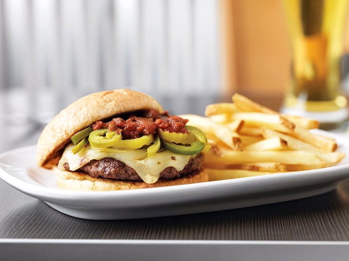 This isn't just a burger &ndash; it's an architectural achievement of beef, cheese, and jalape&ntilde;os that requires both hands and possibly a bib.