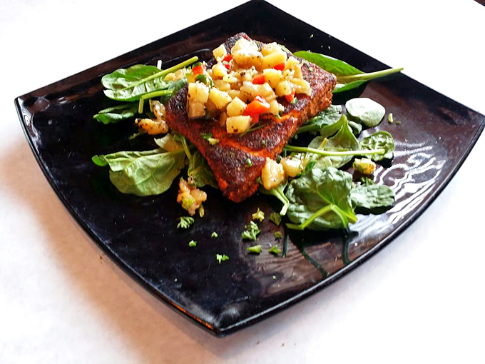 Blackened salmon that's hotter than a Wyoming summer, cooled down with a refreshing pineapple salsa. It's like a tropical vacation on your plate!