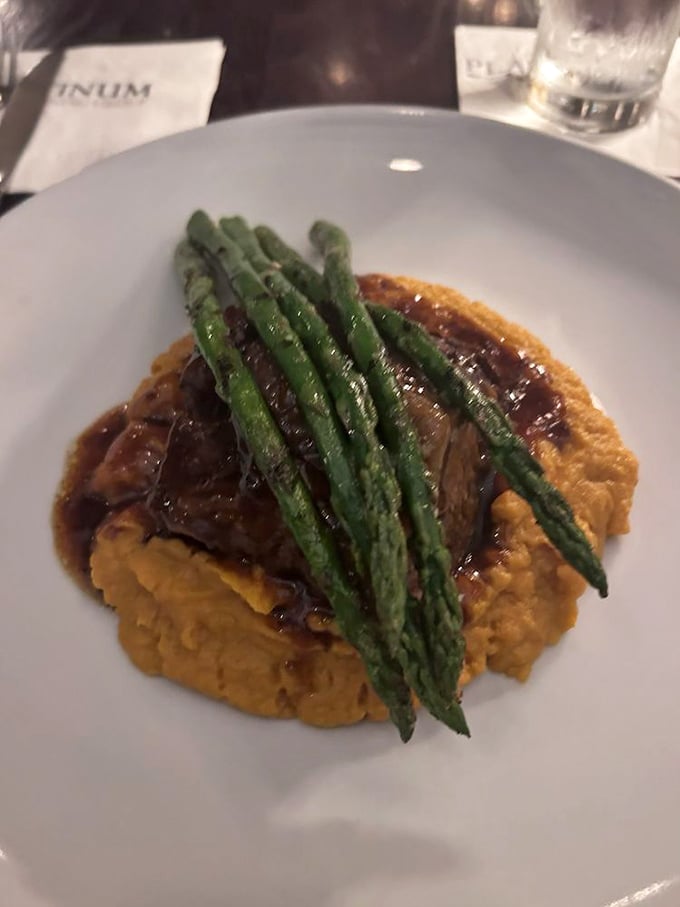 Short ribs so tender, they practically melt onto that vibrant sweet potato mash. It's comfort food elevated to an art form.