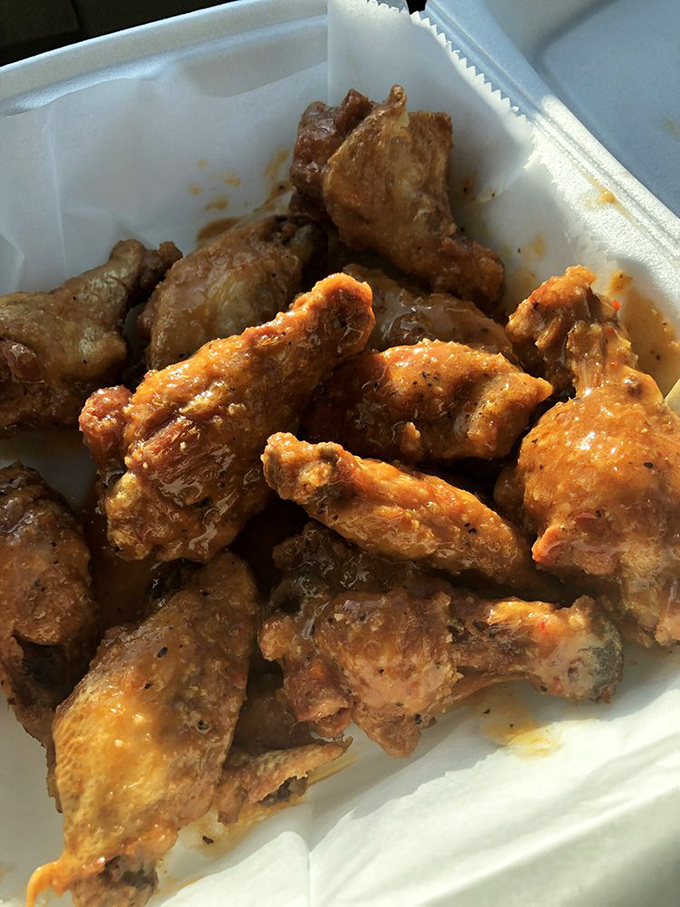 A square white dish becomes a throne for these golden-fried masterpieces. The sauce glistens like amber jewelry, promising flavor that delivers on sight.