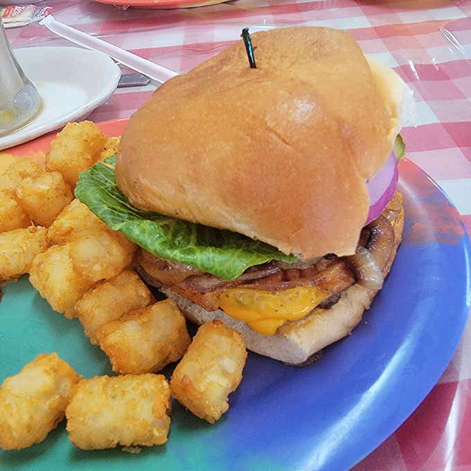 Now that's a burger! Juicy, stacked, and ready to challenge your jaw's flexibility. Napkins are not just suggested &ndash; they're a survival tool.